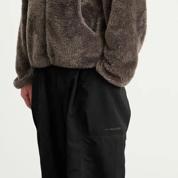 AND WANDER Crinkled Nylon Trousers