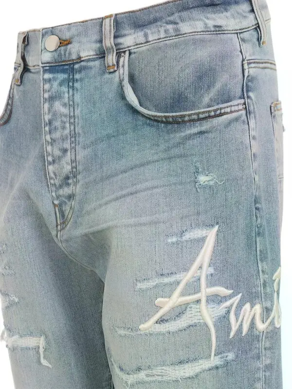 Amiri Distressed Jeans With Signature Embroidery