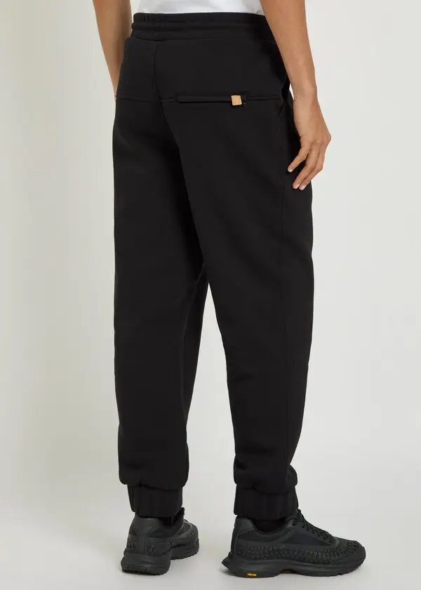 NOW YOU LIVE Magna Logo-embroidered Cotton-blend Sweatpants - Black
