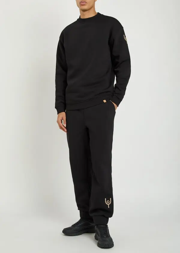 NOW YOU LIVE Magna Logo-embroidered Cotton-blend Sweatpants - Black