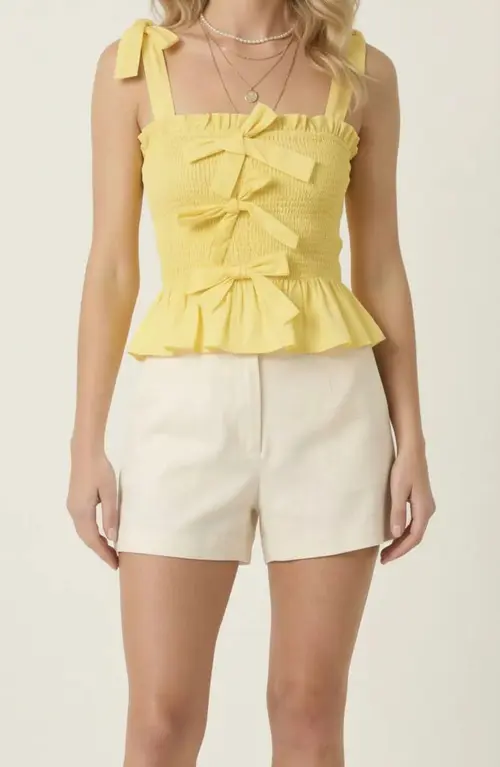 MODENAIRE Smocked Peplum Top With Bow Tie Straps And Ruffle Hem - Yellow