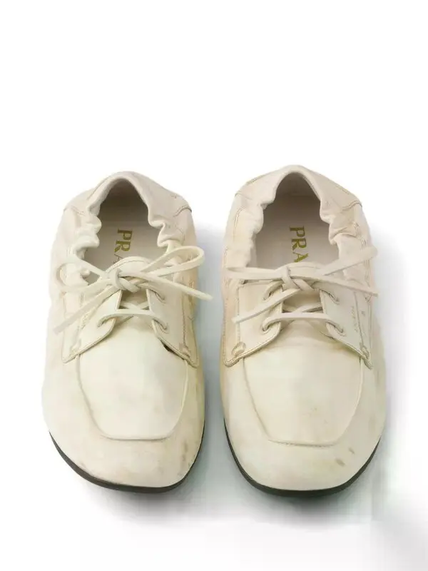 Prada Antiqued Leather Boat Shoes With Lettering Logo - Neutrals