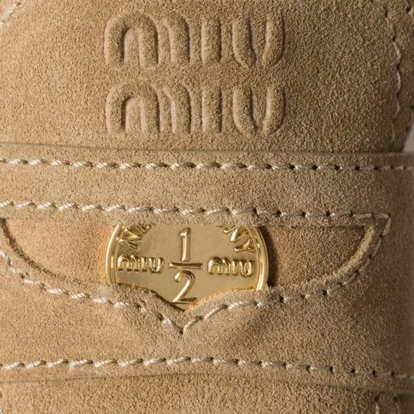 Miu Miu Embossed Logo Slip-on Mules - Beige