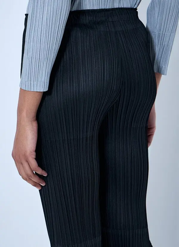 Issey Miyake Mid Rise Flared Pleated Trousers