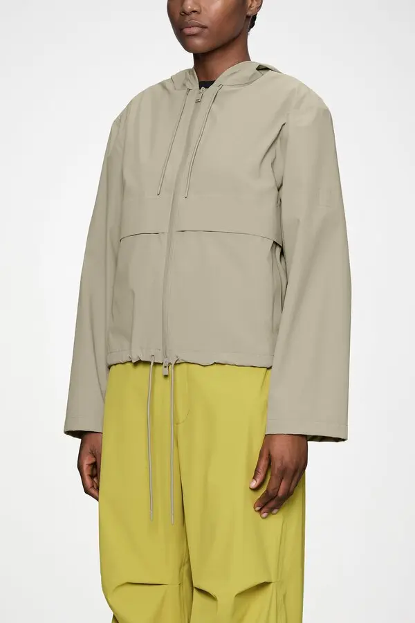 Rains Suva Hardshell Cropped Jacket With Drawstring Hood And Zip Pockets - Beige