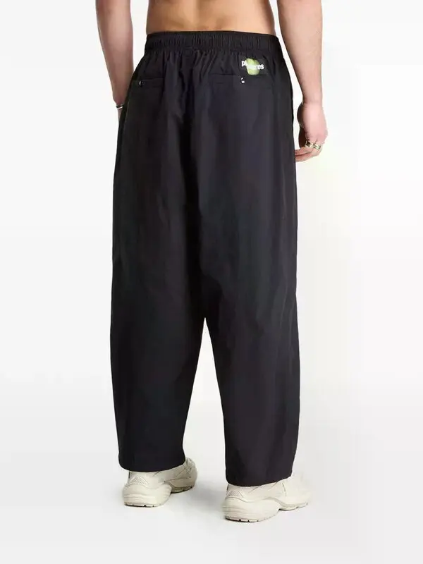 PLEASURES Sound Logo-print Reflective Track Pants