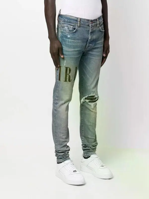 Amiri Distressed Skinny Jeans With Logo Print