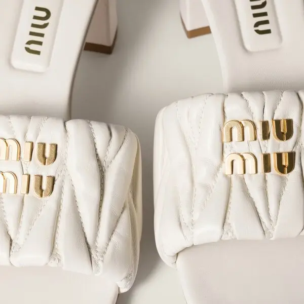 Miu Miu Matelassé Nappa Leather Slides With Gold Lettering Logo - White