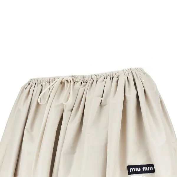 Miu Miu Mini Skirt With Logo Patch - Beige