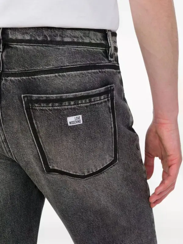 Moschino Faded-effect Logo-patch Jeans