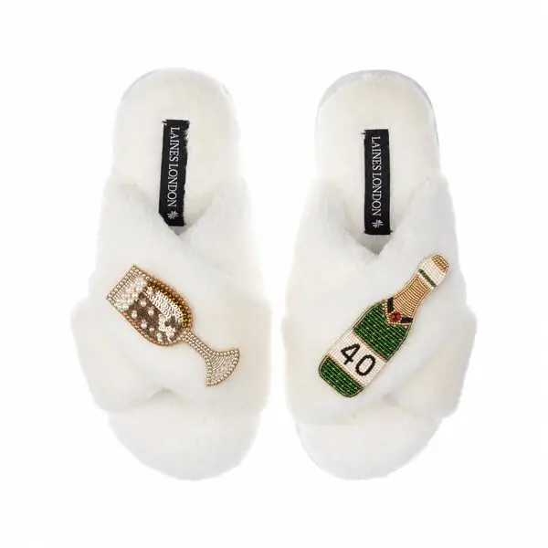 LAINES LONDON Faux Fur Cross Strap Slippers With Embellished Champagne Brooches - White