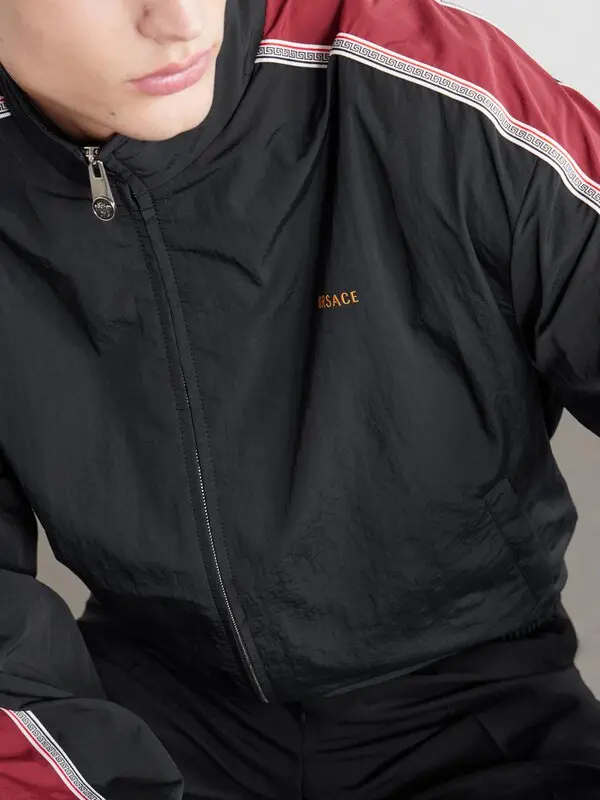 Versace Logo Embroidered Shell Jacket With Greca Motif