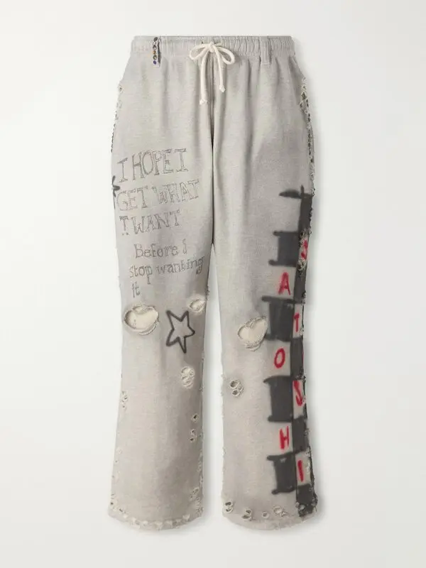 SATOSHI NAKAMOTO Get What I Want Printed Embellished Distressed Cotton-jersey Sweatpants