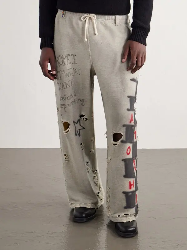 SATOSHI NAKAMOTO Get What I Want Printed Embellished Distressed Cotton-jersey Sweatpants