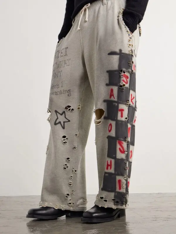SATOSHI NAKAMOTO Get What I Want Printed Embellished Distressed Cotton-jersey Sweatpants