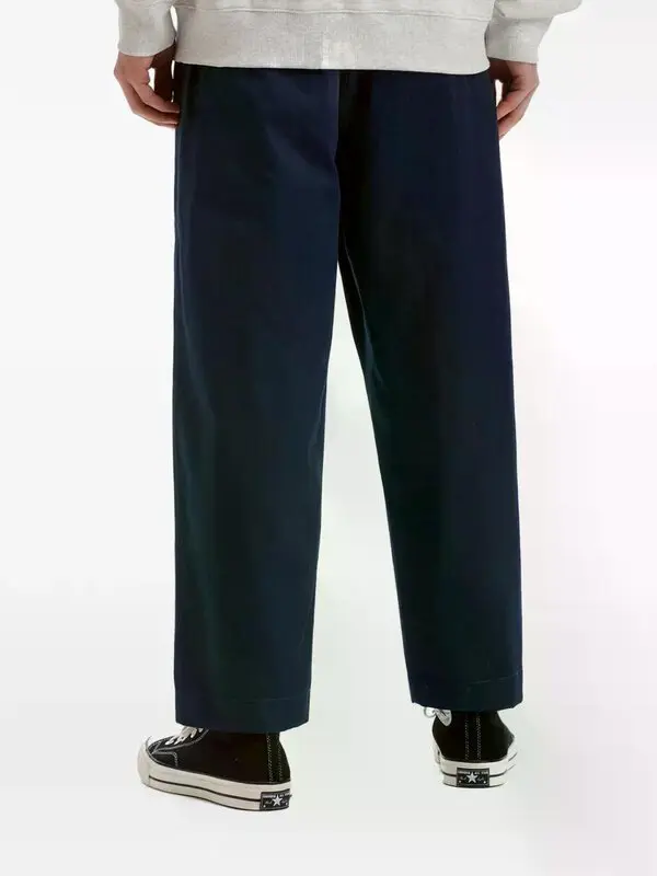 FINGERCROXX Pleated Logo-patch Trousers