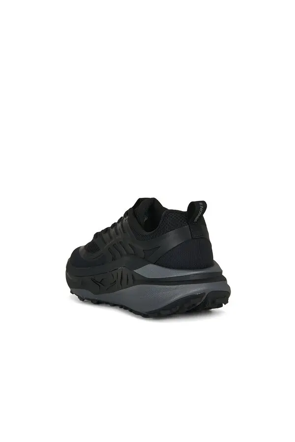 HOKA® Stinson Sneaker In Black - Black & Outer Orbit