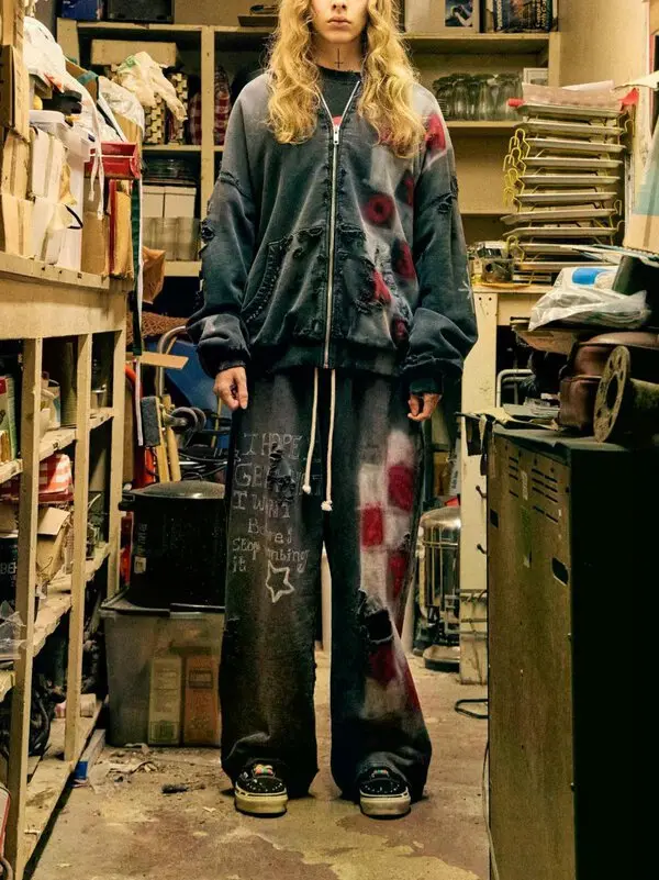 SATOSHI NAKAMOTO Get What I Want Distressed Graffiti-print Trousers