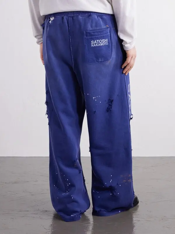 SATOSHI NAKAMOTO Luke Logo-printed Paint-splattered Distressed Cotton-jersey Drawstring Sweatpants