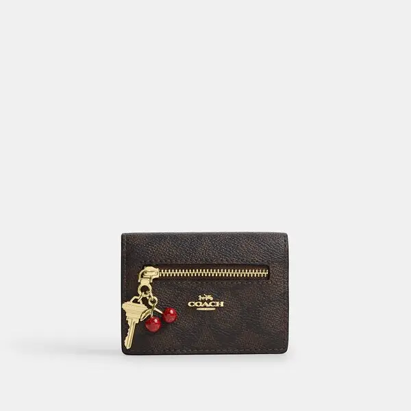 COACH OUTLET Card Case With Charms In Signature Canvas - Gold/walnut/black