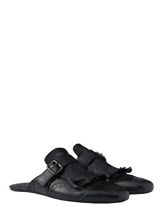 Prada Antiqued Leather Mules With Buckled Strap And Fringe - Black