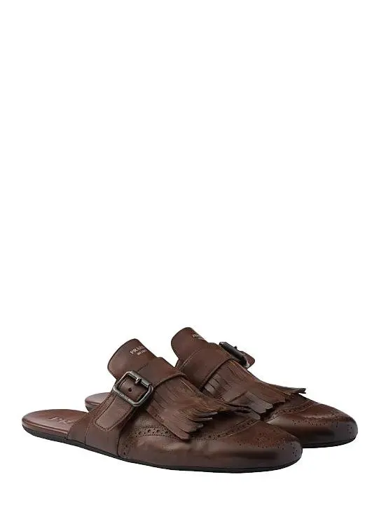 Prada Antiqued Leather Mules With Buckled Strap And Fringe - Brown