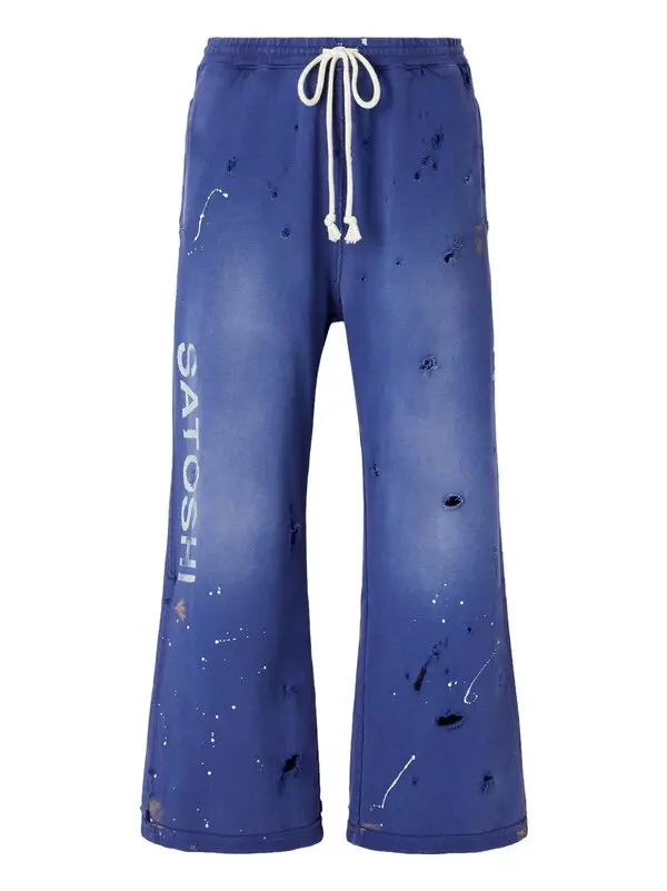 SATOSHI NAKAMOTO Luke Logo-printed Paint-splattered Distressed Cotton-jersey Drawstring Sweatpants - Blue