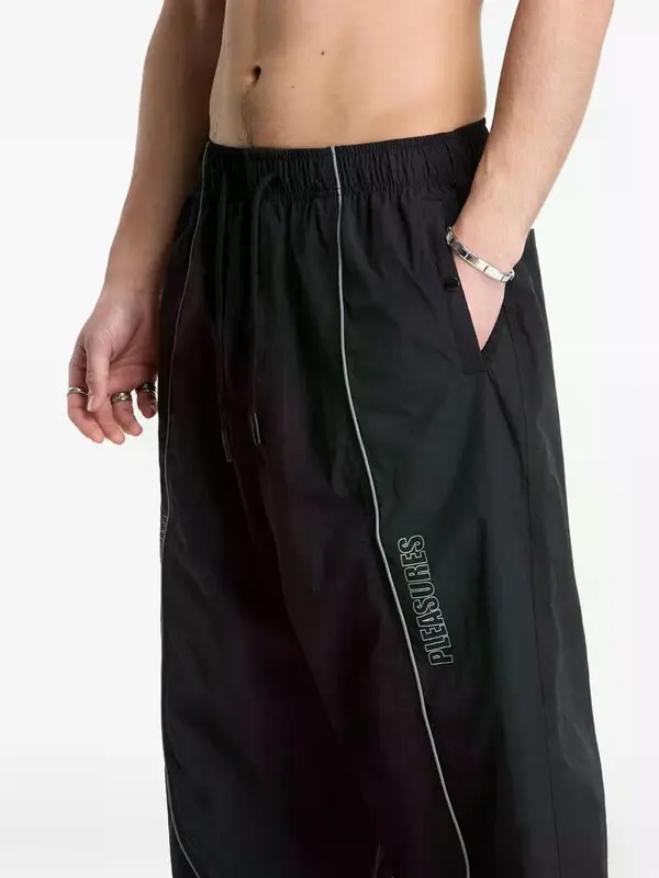 PLEASURES Sound Logo-print Reflective Piping Track Pants