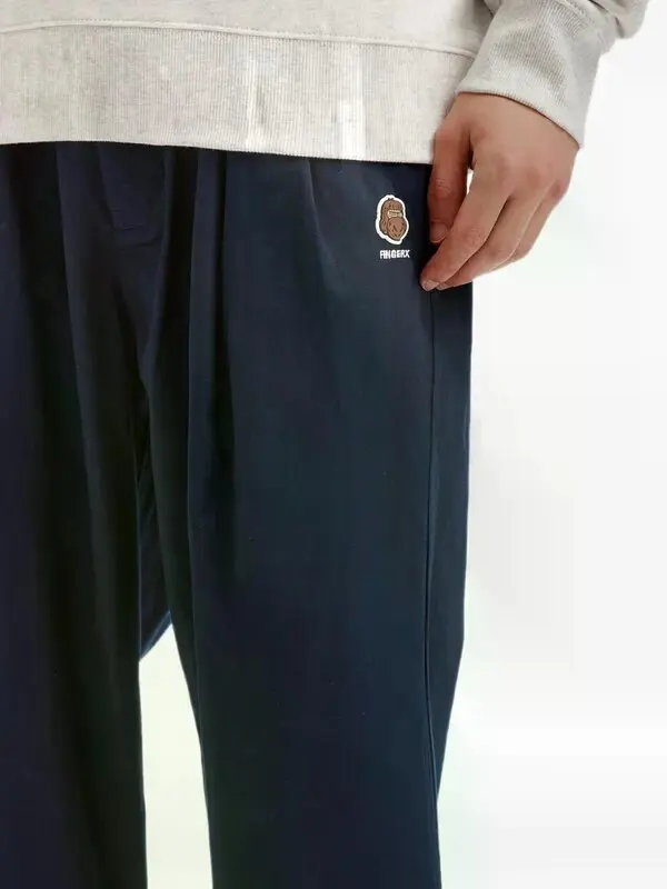 FINGERCROXX Pleated Logo-patch Trousers