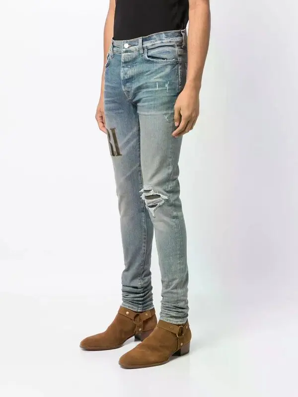 Amiri Logo-embroidered Ripped-detail Jeans
