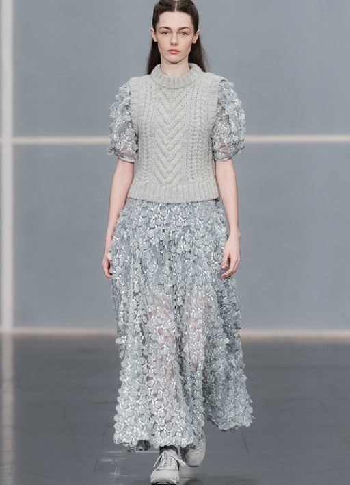 Cecilie Bahnsen FW20 look featuring a light gray knitted vest paired with an ethereal sheer floral skirt and stylish sneakers, embodying modern elegance