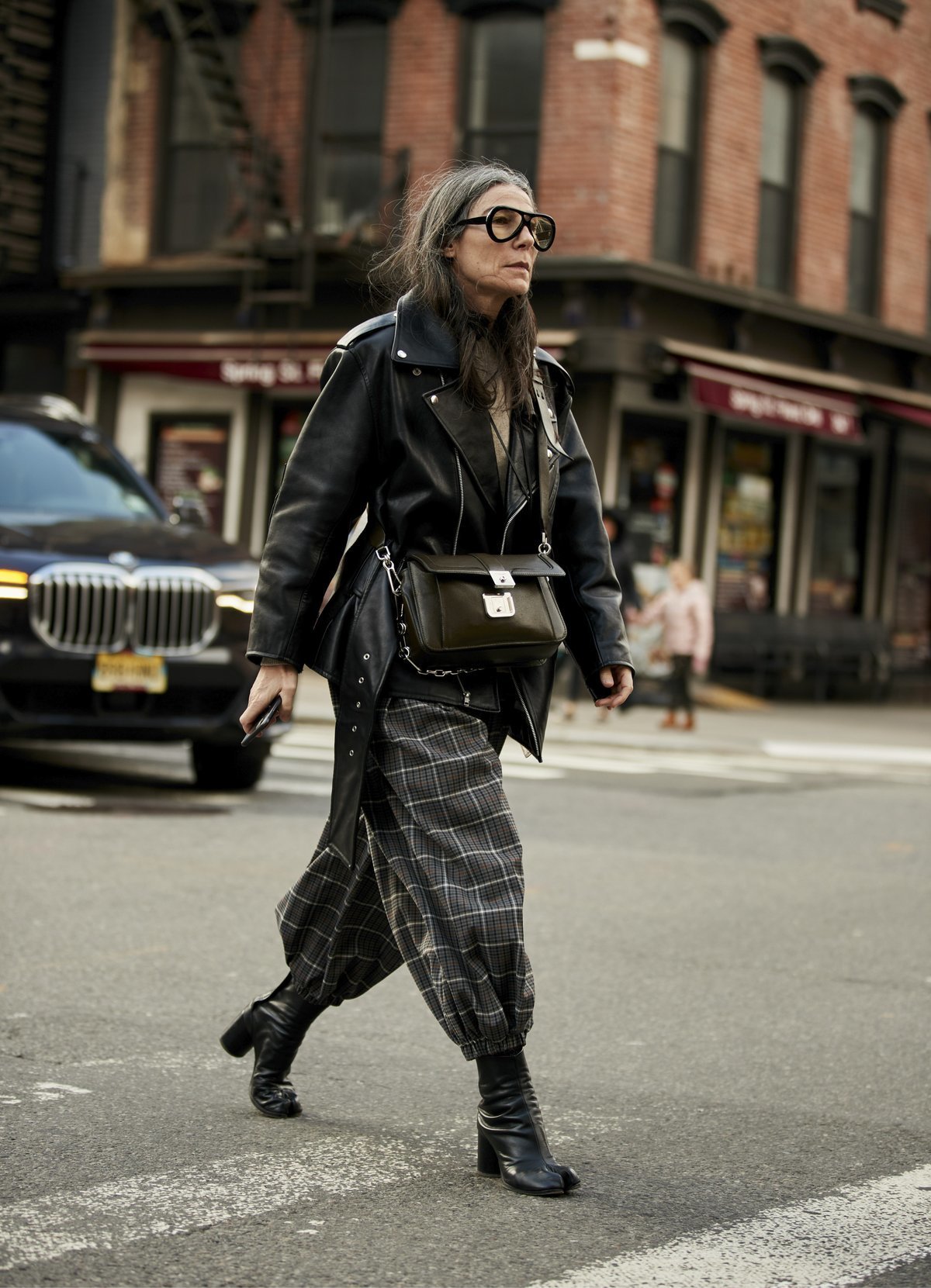 Bottega Veneta crossbody bag featuring a rich brown woven leather design, perfect for sustainable and stylish outfits in 2024