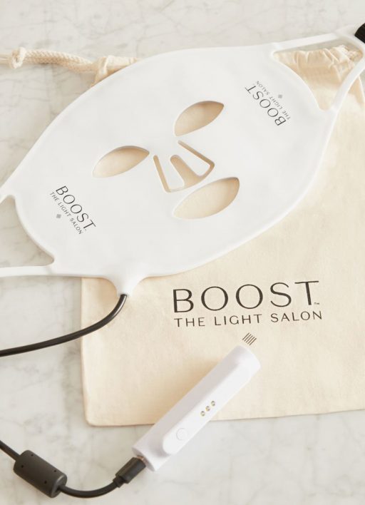 A Light Salons boost led mask lies on a white marble. 