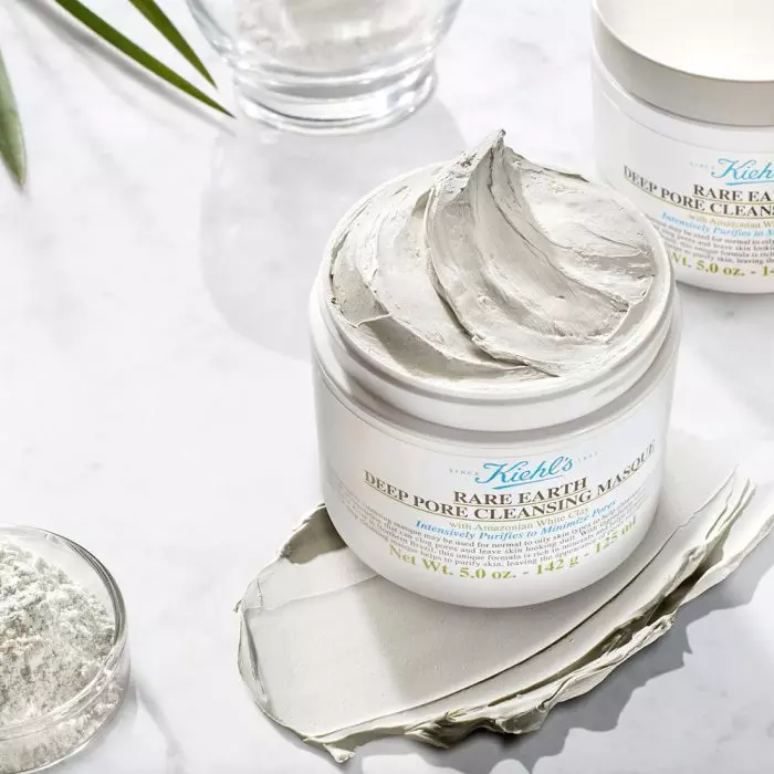 On a table lies a bottle of Kiehl's clay mask.