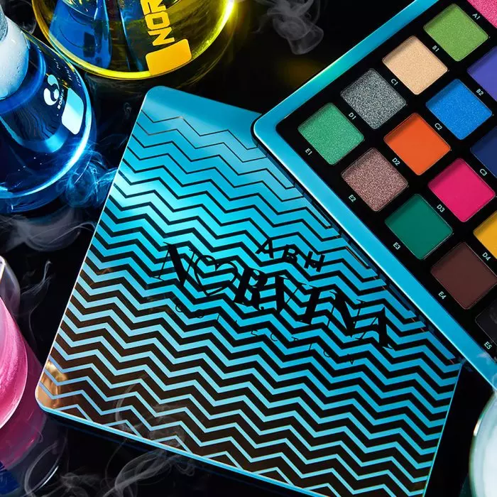 A setup containing the Norvina collection eyeshadow palette in dark lighting.