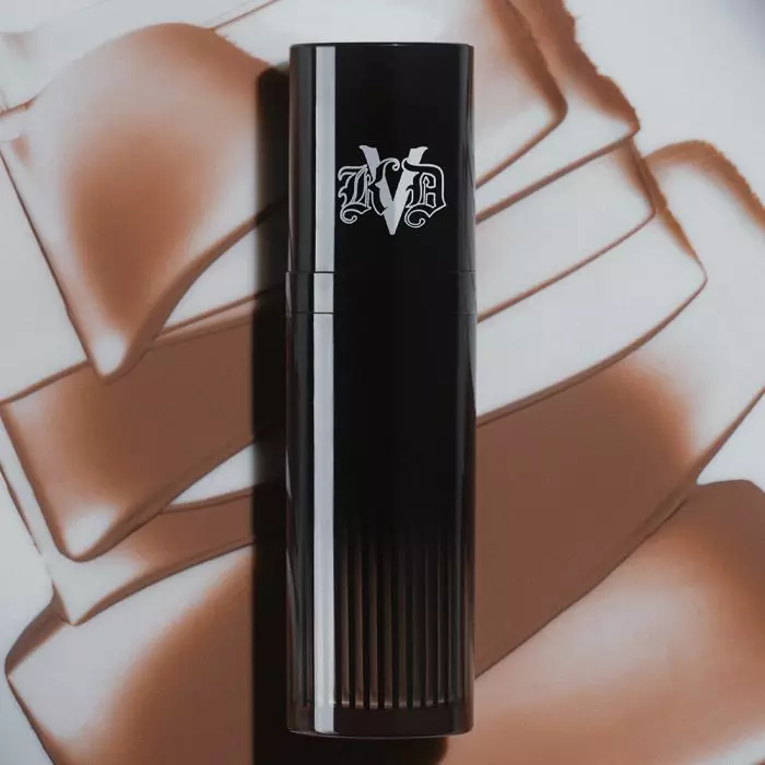 A black tube of liquid contours lies on a pool of liquid.