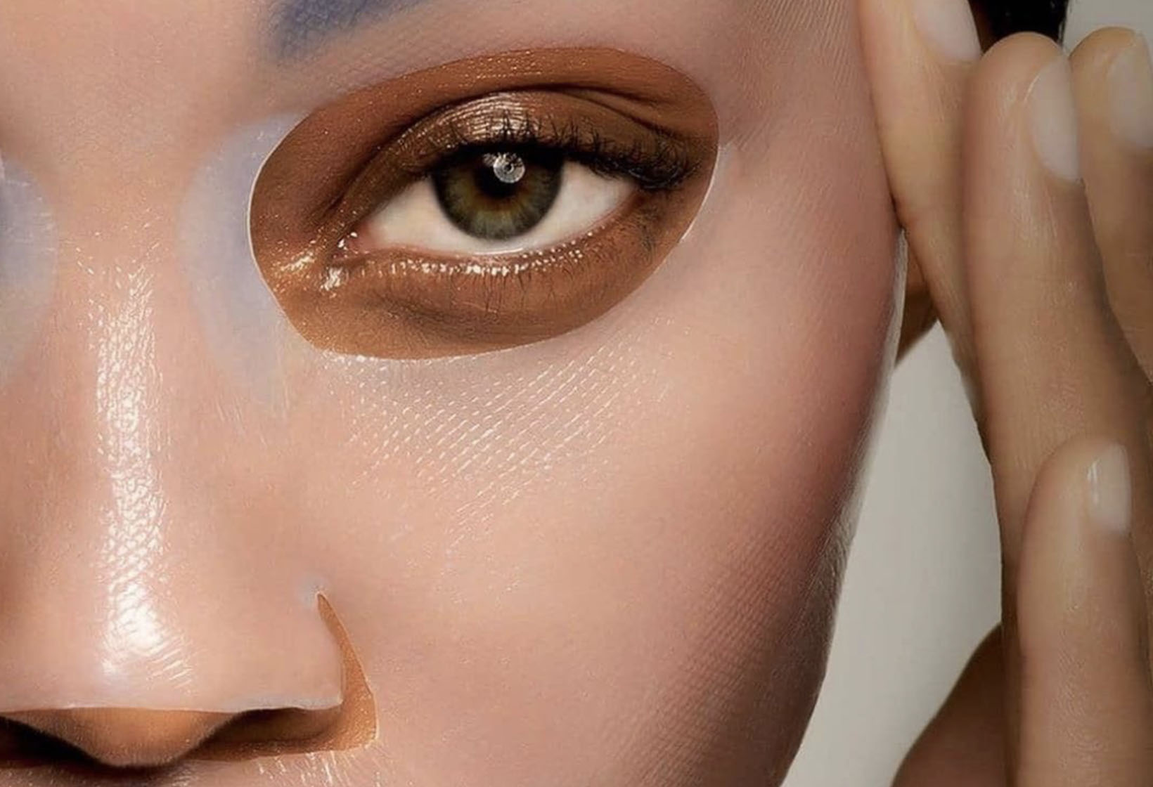 Close-up of a model applying a hydrating sheet mask%2C showcasing glistening skin and perfectly defined eye makeup%2C ideal for skincare enthusiasts