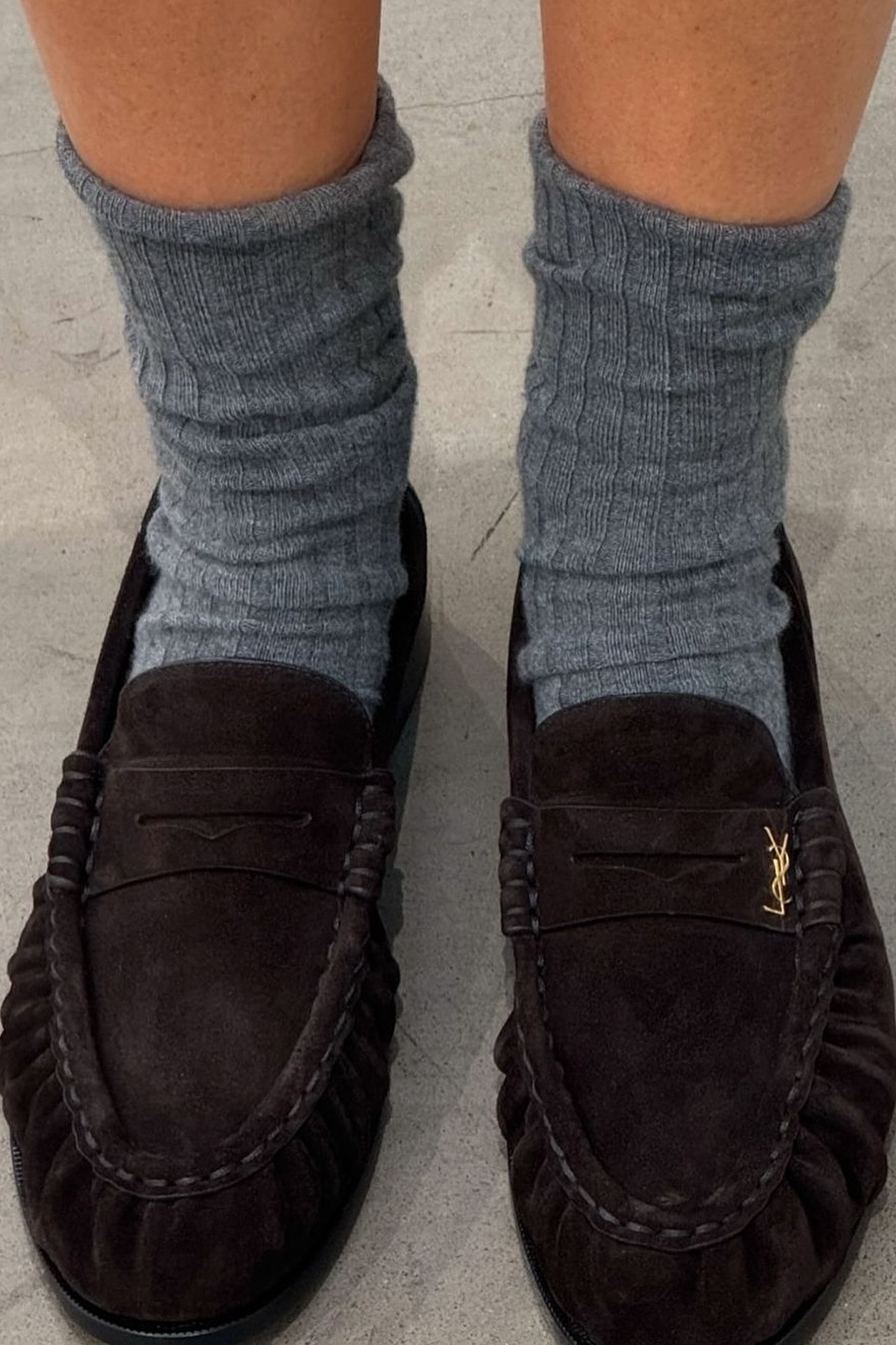 Cozy cashmere socks in a soft gray hue%2C styled with luxurious dark brown loafers%2C perfect for a chic winter look