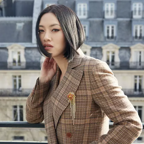 Portrait of fashion expert Tiffany Hsu wearing a blazer and a brooch.