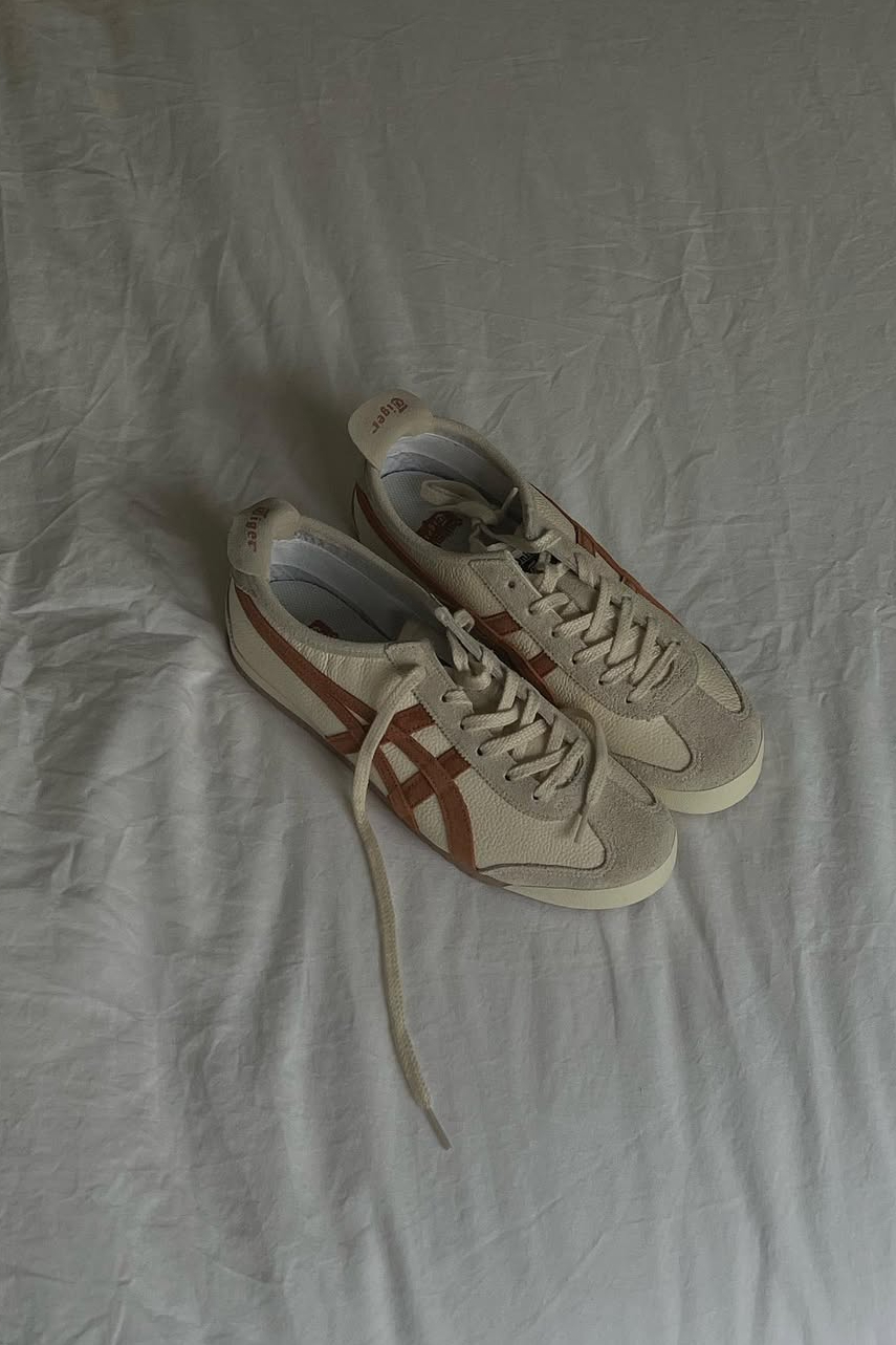 Onitsuka Tiger sneakers in beige suede and leather with brown accents%2C displayed on a soft white surface%2C perfect for summer outings