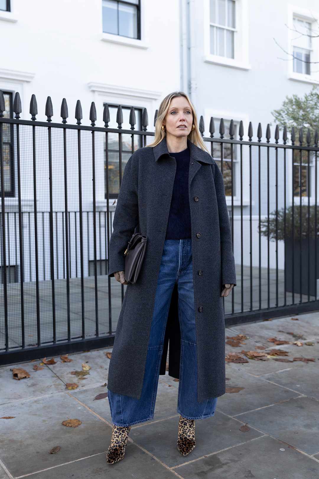 Chic wool coat in charcoal gray layered over a navy sweater%2C paired with wide-leg denim and stylish leopard-print heels%2C exuding sophisticated autumn fashion