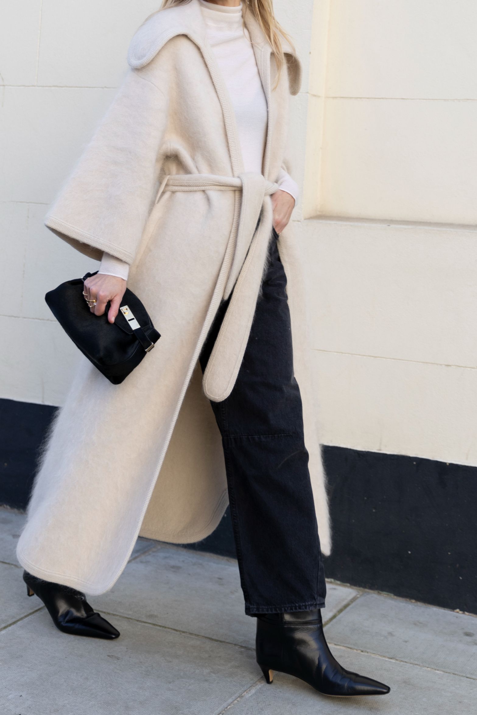 Cozy beige wrap coat with oversized collar%2C paired with fitted black jeans and stylish black heeled ankle boots%2C perfect for winter outings