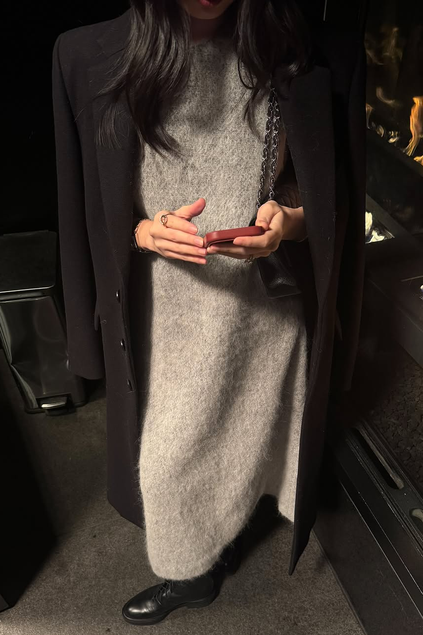 Knit dress in soft gray wool paired with a tailored black coat and black lace-up boots%2C ideal for transitional winter to spring style