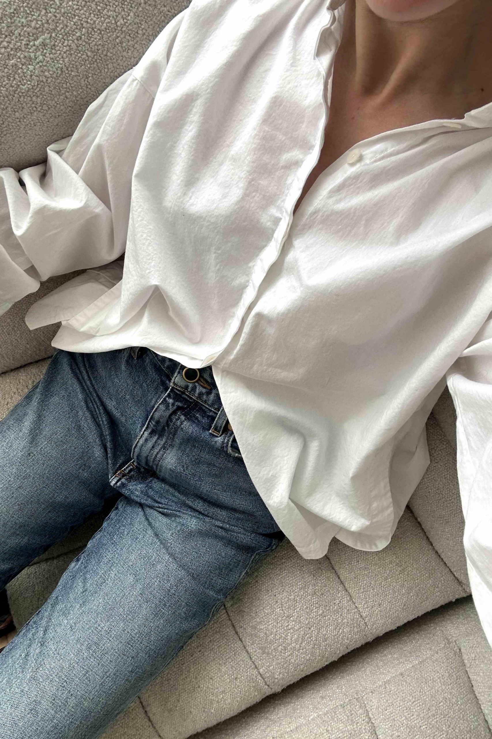 Khaite Abigail jeans styled with an oversized white cotton button-down for a relaxed%2C effortless everyday look
