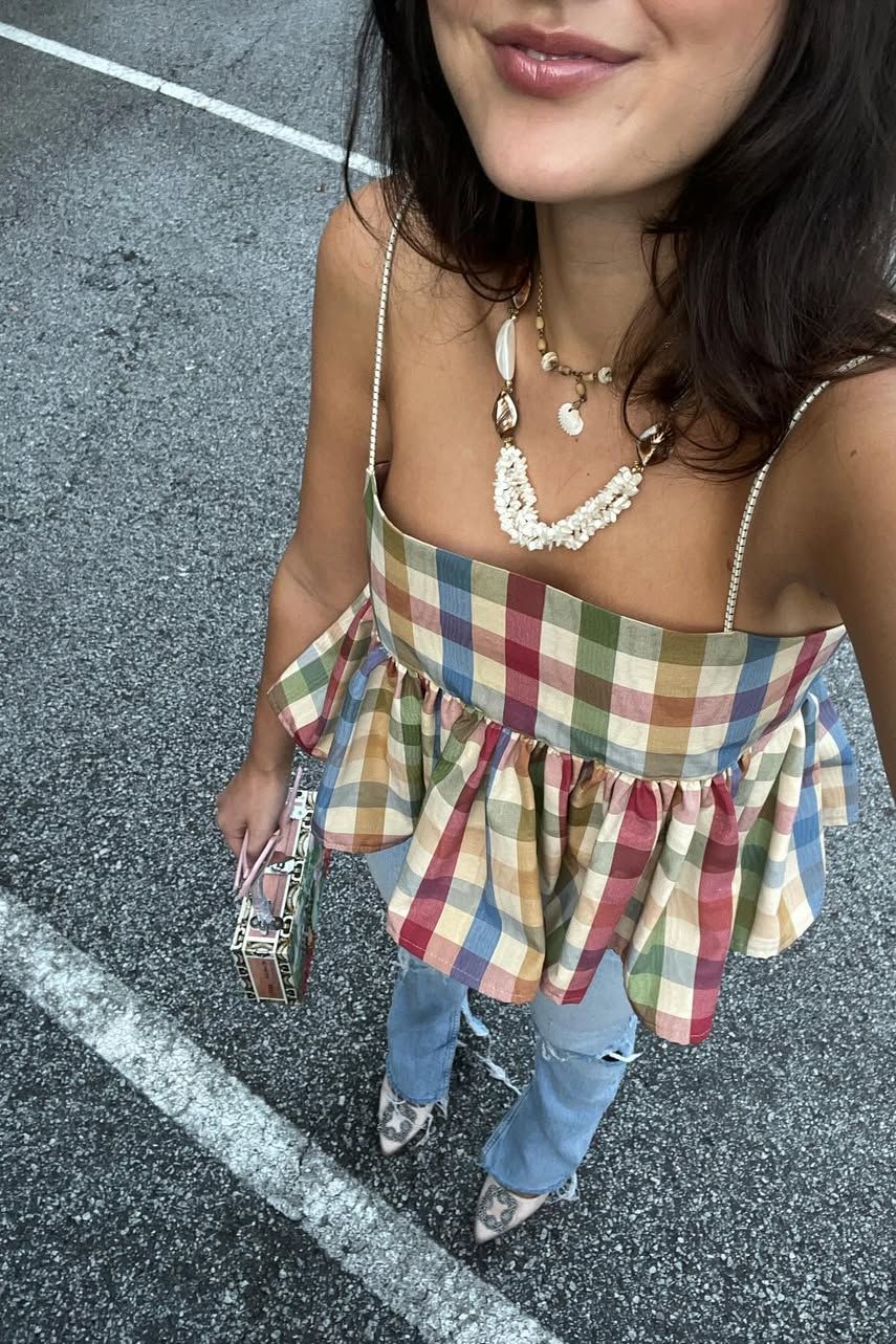 Gingham peplum top in multi-color checks paired with distressed jeans%2C accessorized with a vintage-style handbag and layered necklaces