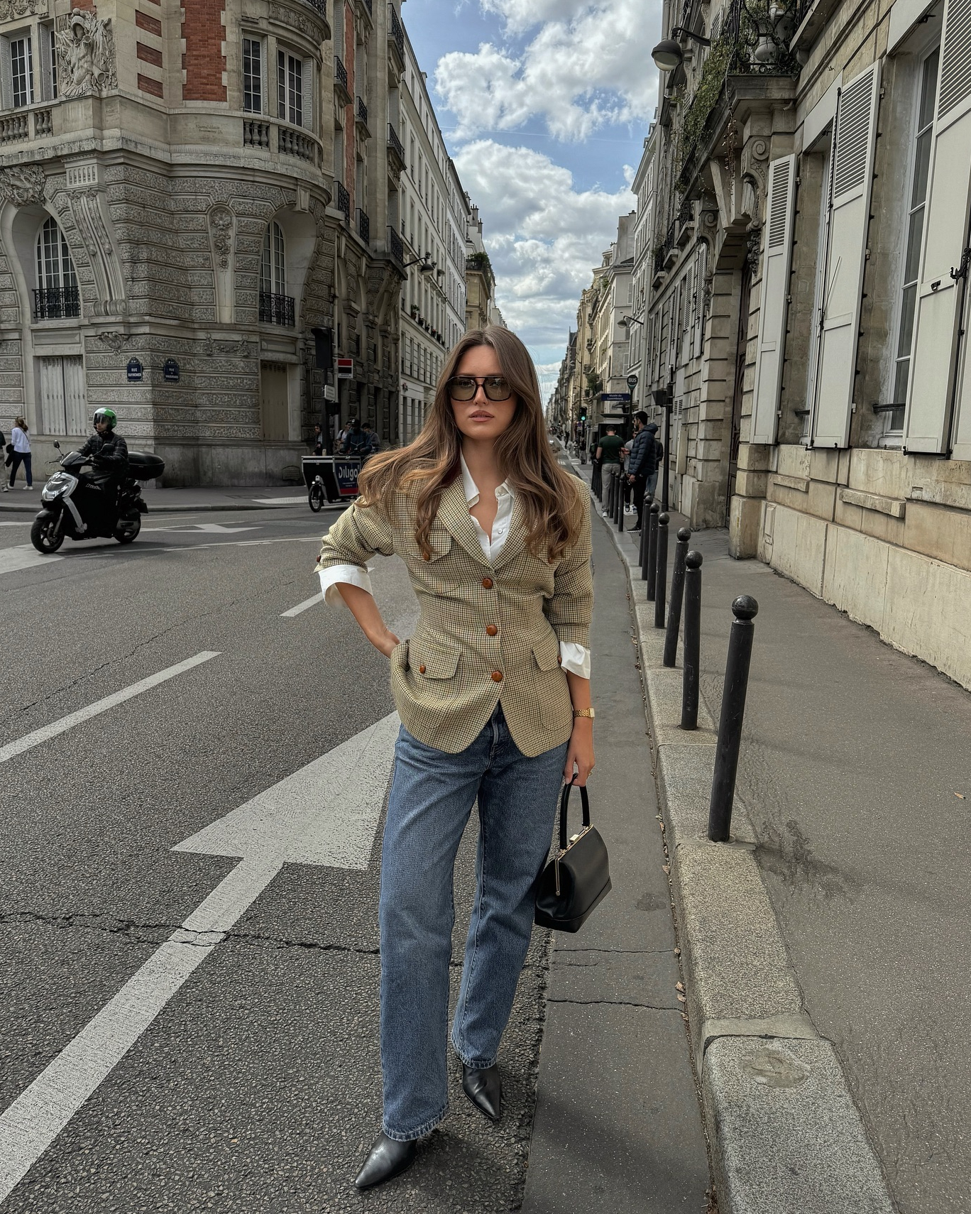 French girl street style with beige tailored blazer%2C white shirt%2C relaxed jeans and black leather handbag on a Paris street