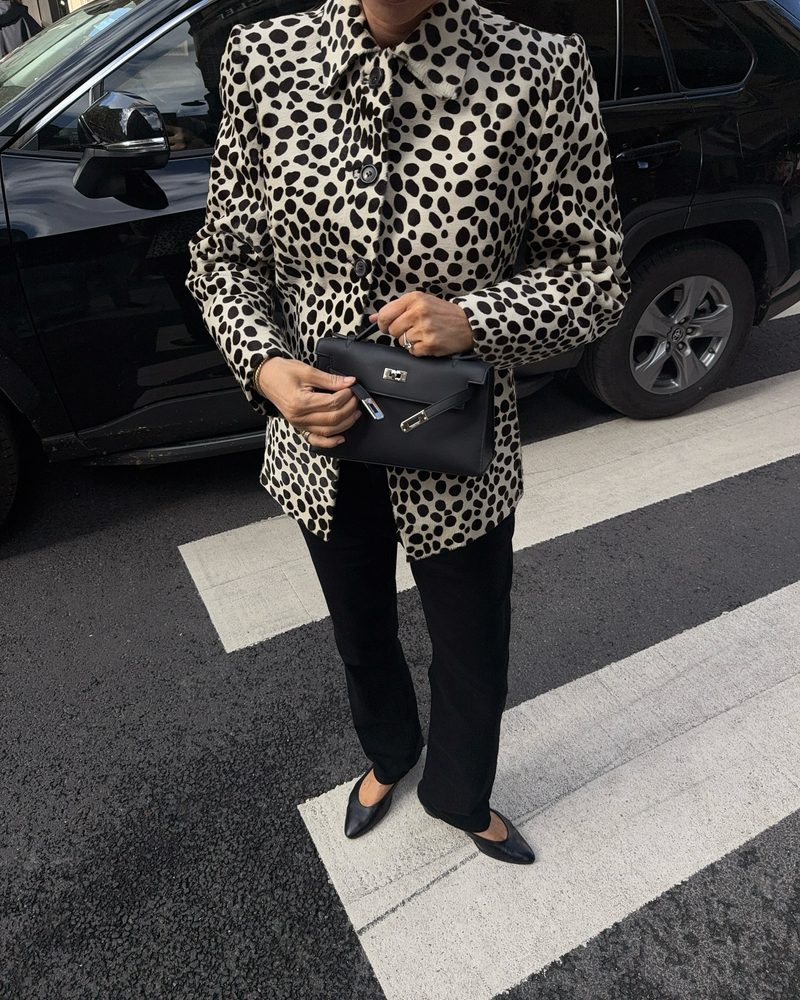 Polka dot print coat featuring a classic button-up design%2C paired with tailored black pants and sleek black flats for a chic look.