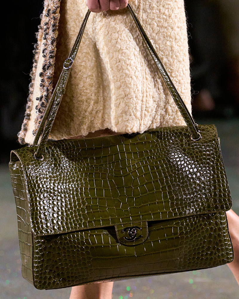 Chanel olive green croc-embossed flap bag with CC clasp and shoulder straps%2C styled with a cream textured coat