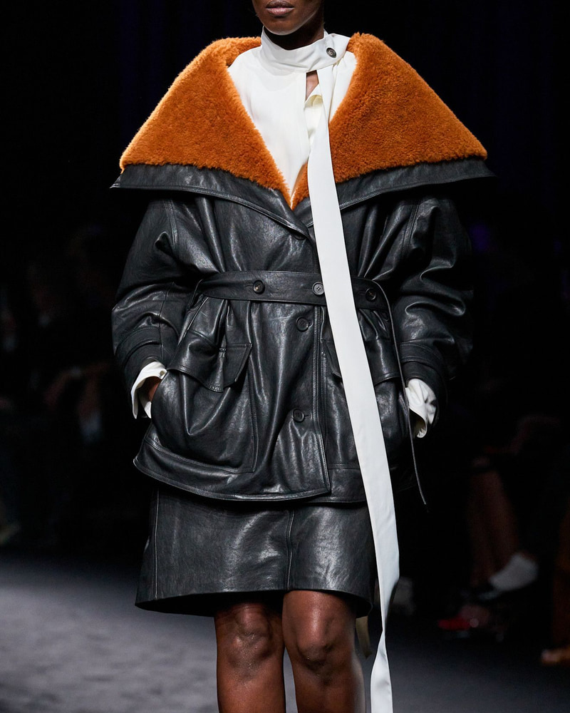 Black leather Ferragamo jacket with oversized burnt orange shearling collar and matching leather skirt for fall winter fashion
