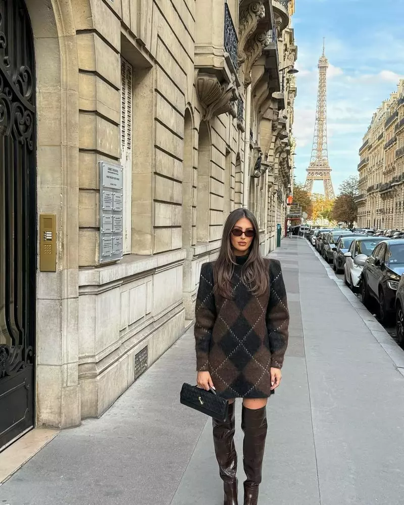 Paris street style look in argyle knit mini dress%2C knee-high leather boots and clutch%2C styled near the Eiffel Tower